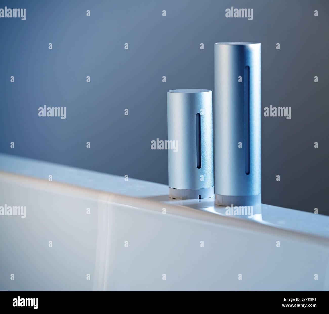 A sleek aluminum weather station placed on white shelves with a ...