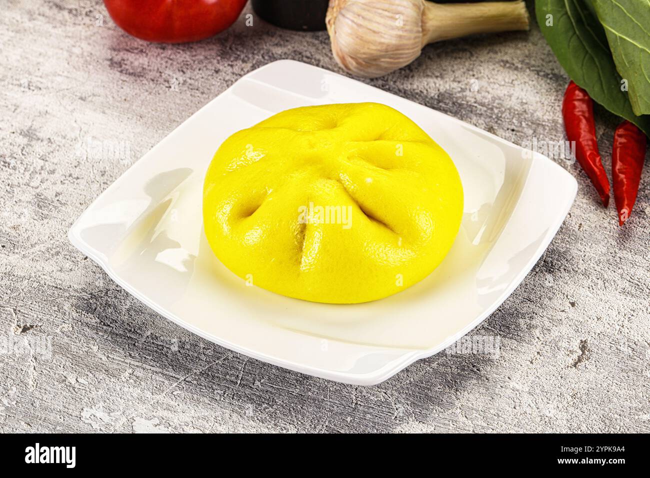 Asian stuffed steamed yellow Bun Bao Stock Photo - Alamy