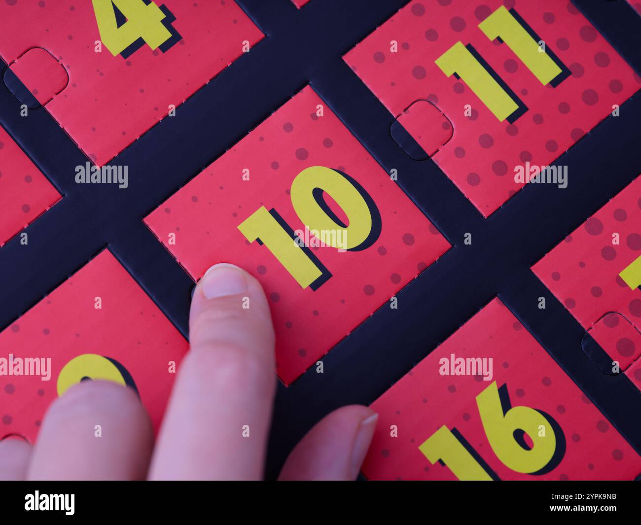 Woman finger ready to open the door with number 10 on the advent ...