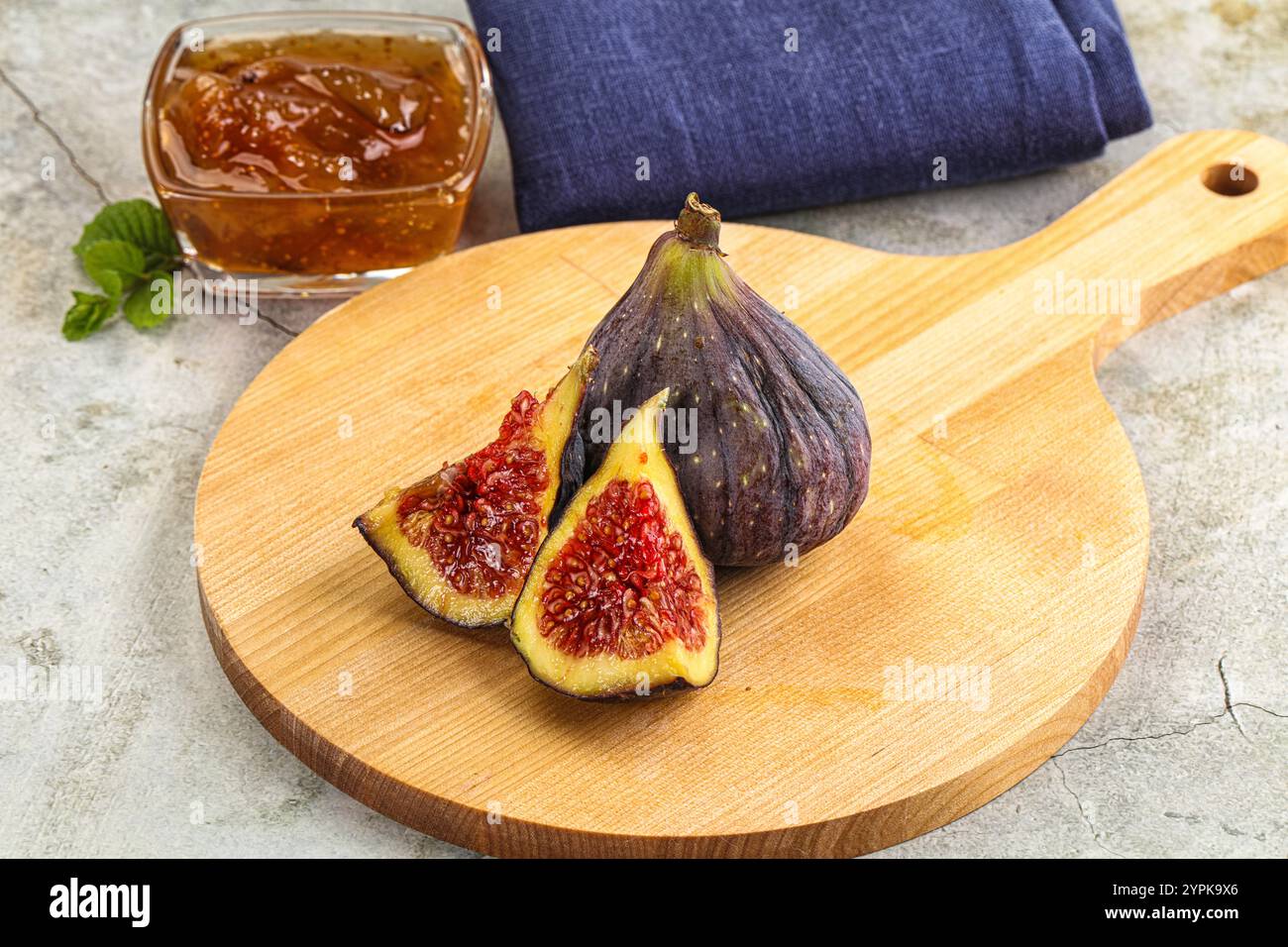 Purple ripe sweet fig with cut Stock Photo - Alamy