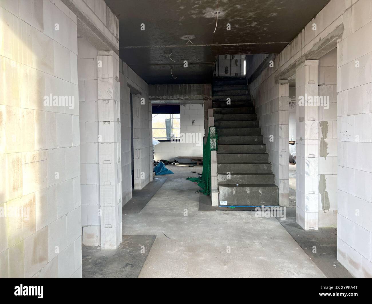 Inside view of a new building with concrete stairs, core and shell ...
