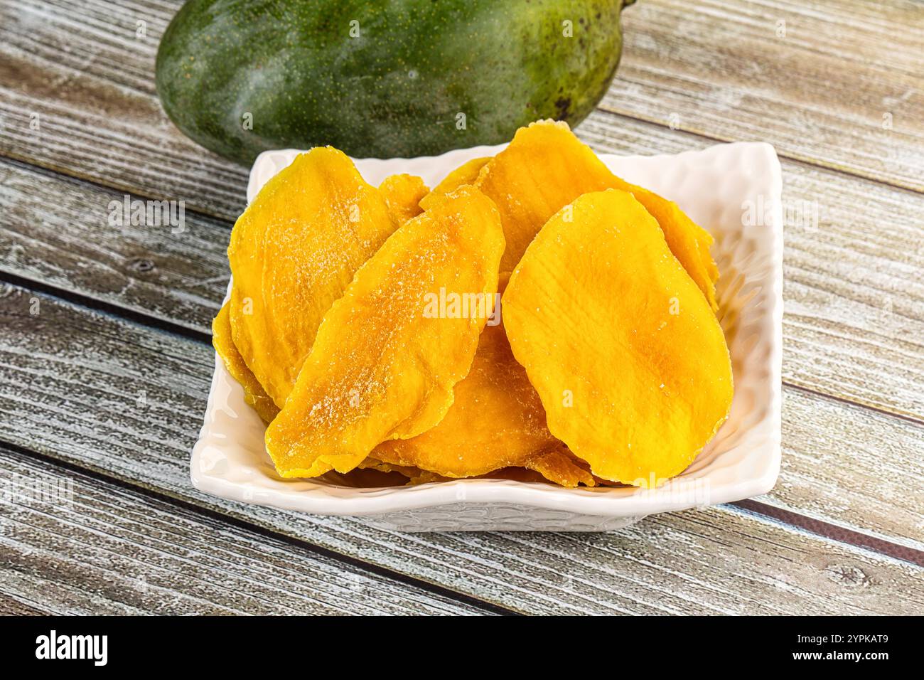 Dry sweet yellow mango snack in the plate Stock Photo - Alamy