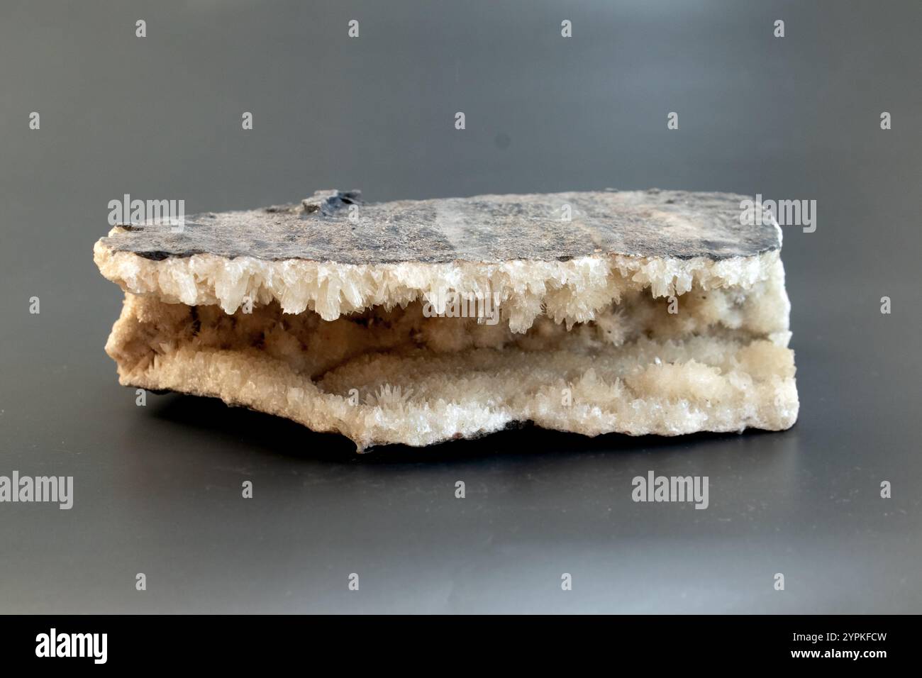 Manganoan calcite natural mineral stones and gemstones on grey paper ...