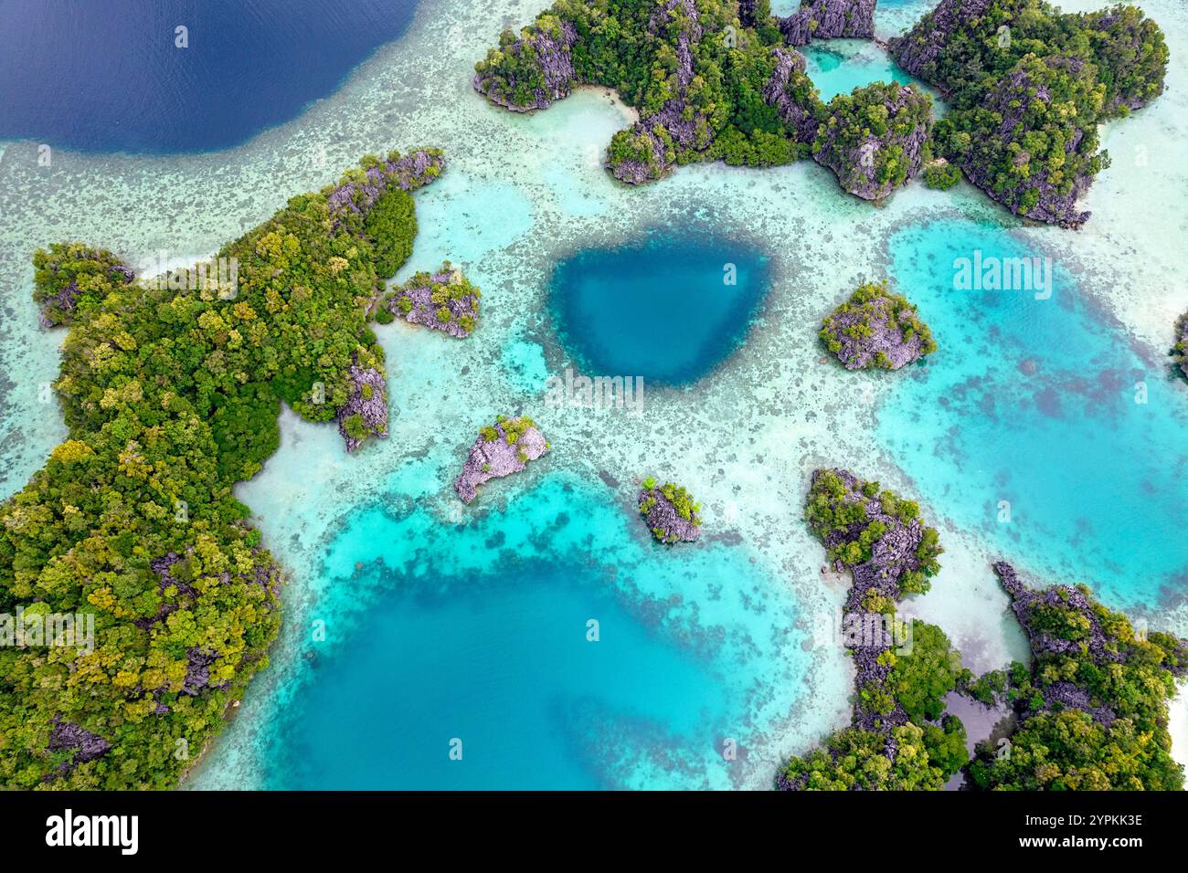 Aerial view of spectacular lagoons and blue holes, small islands ...