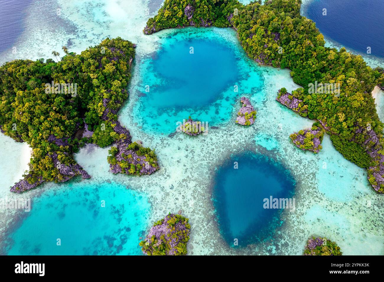 Aerial view of spectacular lagoons and blue holes, small islands ...