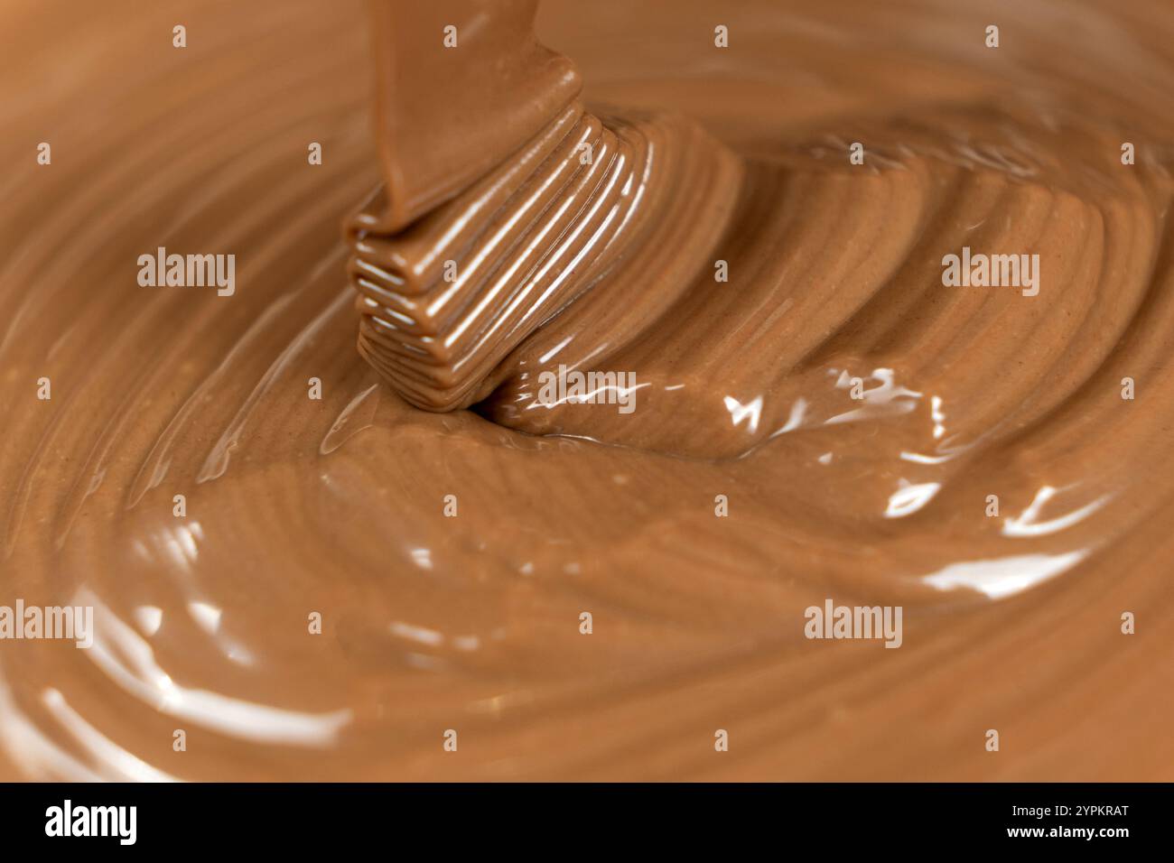 Flow of melted milk liquid chocolate, close-up Stock Photo - Alamy