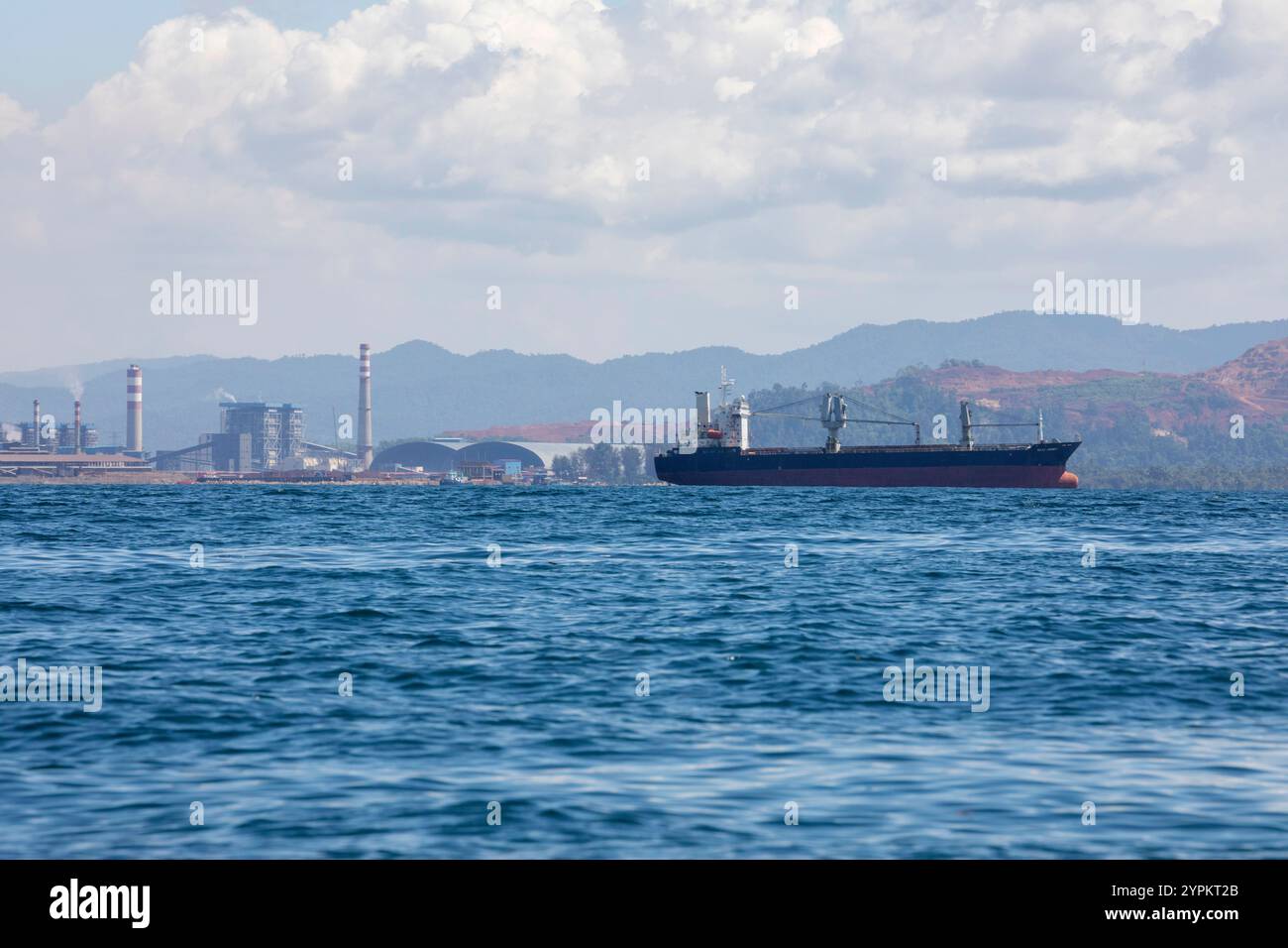 Cargo ships close to nickel open pit mines and factories of nickel ...