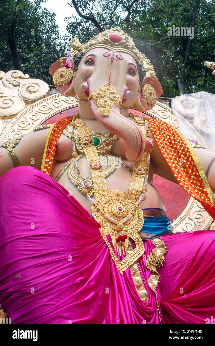 A beautiful idol of Lord Ganpati being displayed in a procession called ...