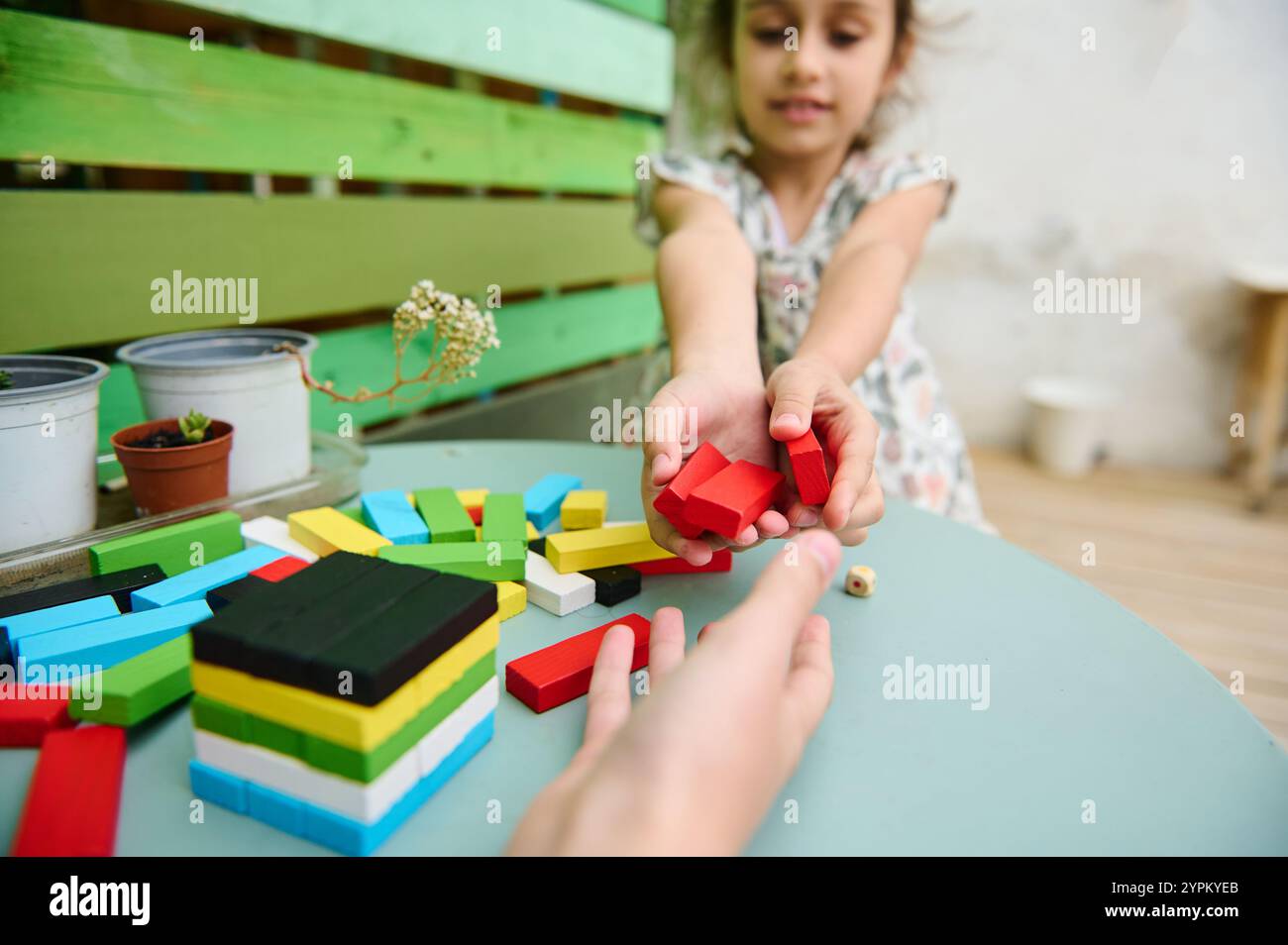A young child enthusiastically engages in a playful activity with ...