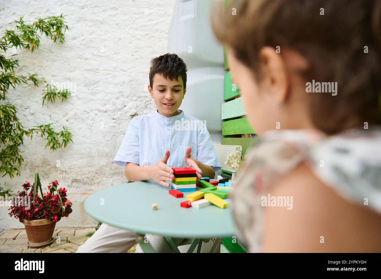 Happy children enjoying wooden games hi-res stock photography and ...