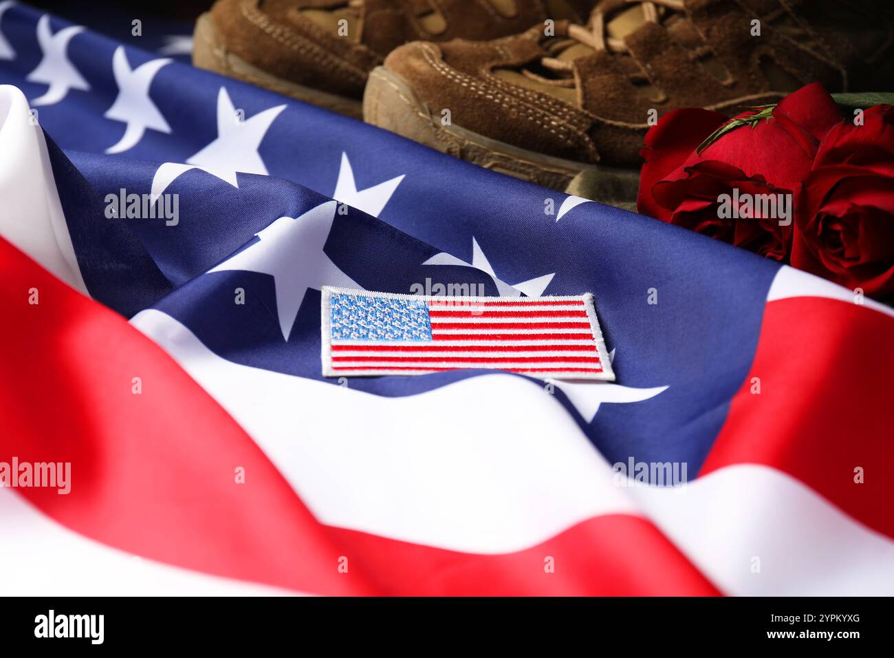 Veterans day. USA army patch, American flag, roses and military shoes ...