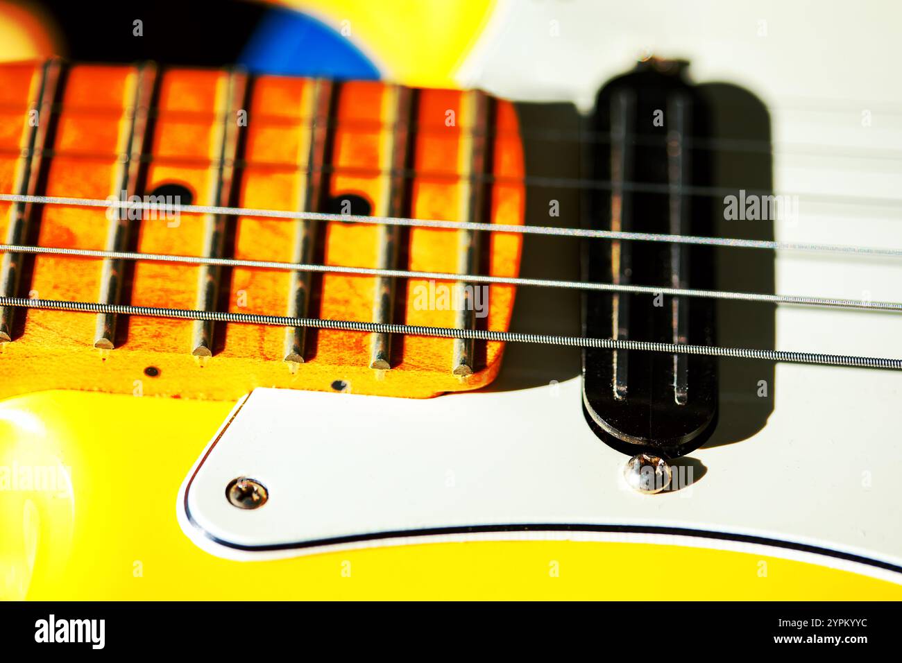 Guitar neck and body, featuring a bright yellow finish and a maple ...