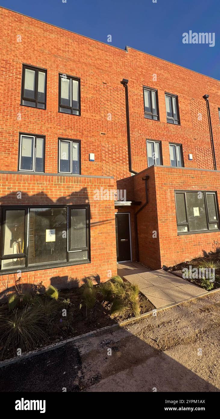 New brick building with multiple windows, a single entrance, and ...