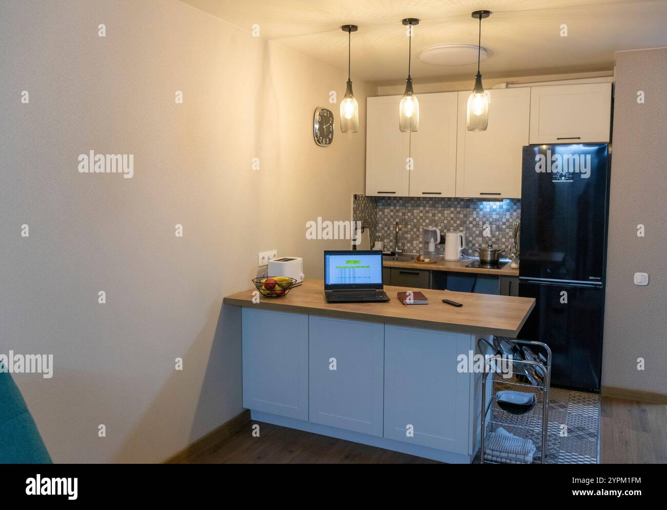Laptop on the kitchen counter top with an excel sheet on computer ...