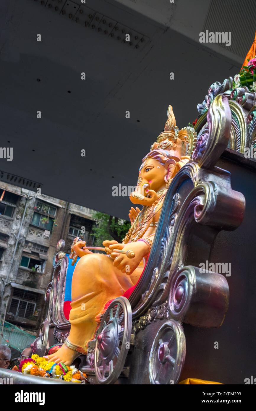 A beautiful idol of Lord Ganpati being displayed in a procession called ...