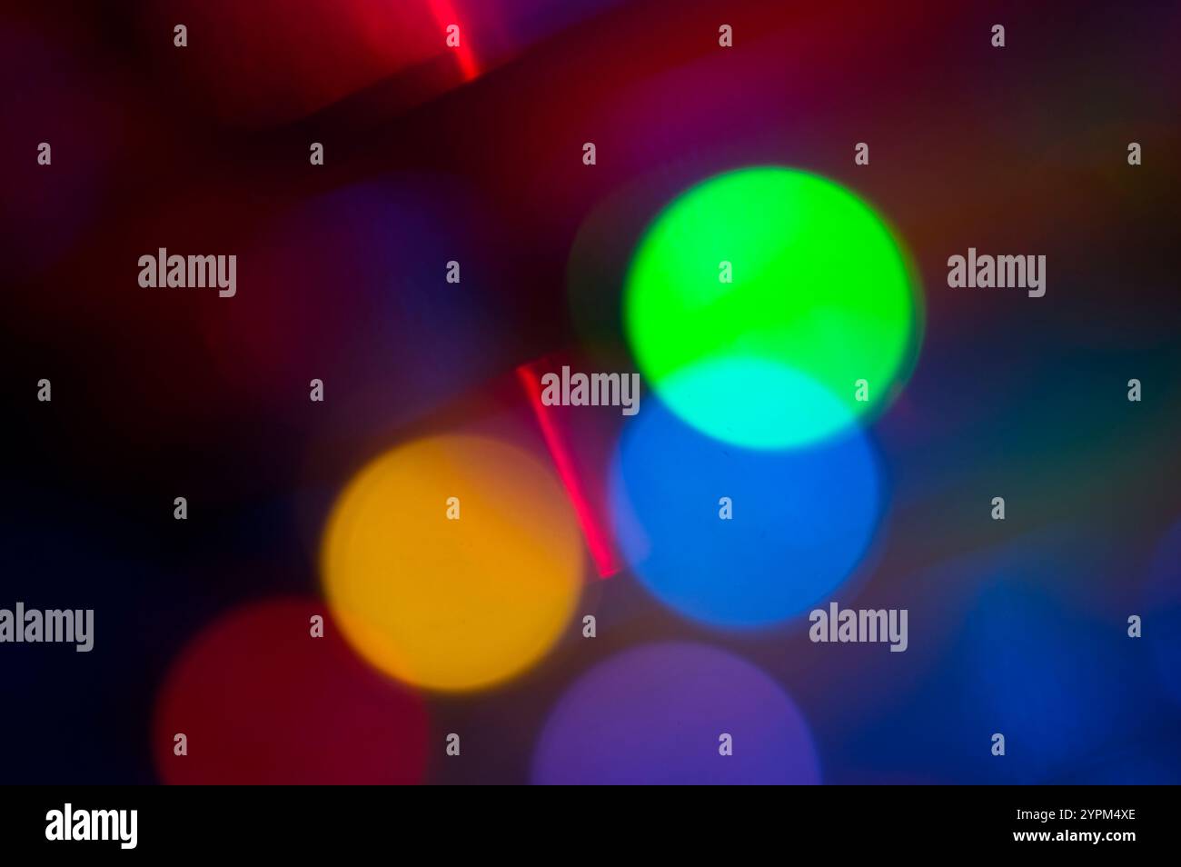 Glowing orbs of overlapping light in yellow, orange, blue and red on a ...