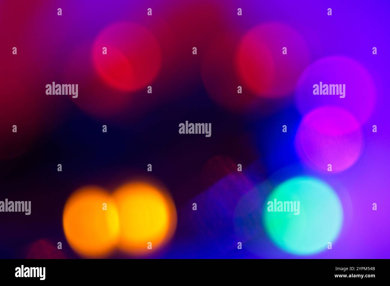 Colored orbs of red, yellow and blue light in an abstract Stock Photo ...