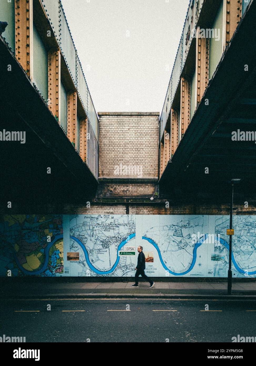 Urban Underpass with Historical Map Mural and Pedestrian in Industrial ...