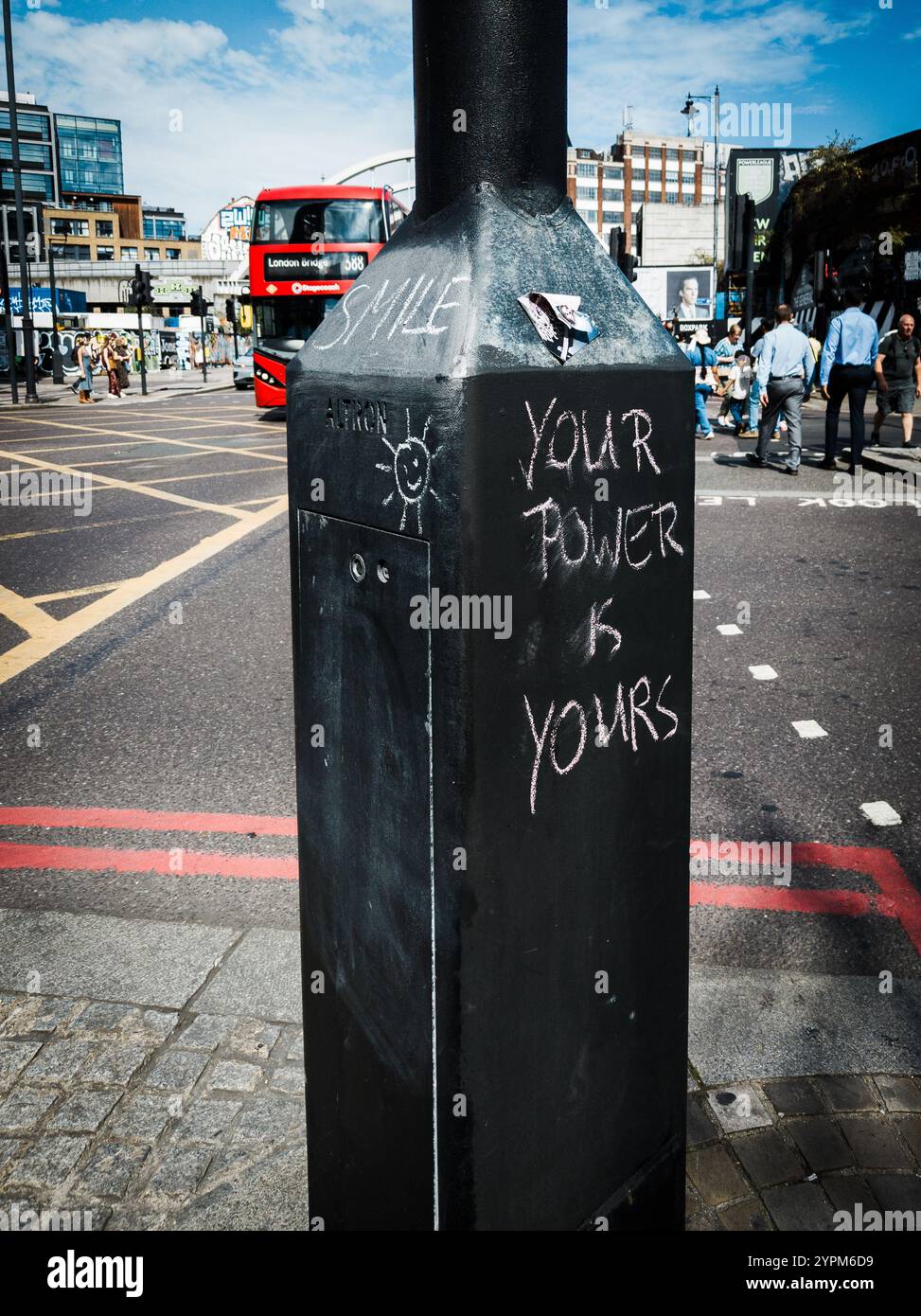 Urban Street Scene with Motivational Chalk Art and Red London Bus in ...