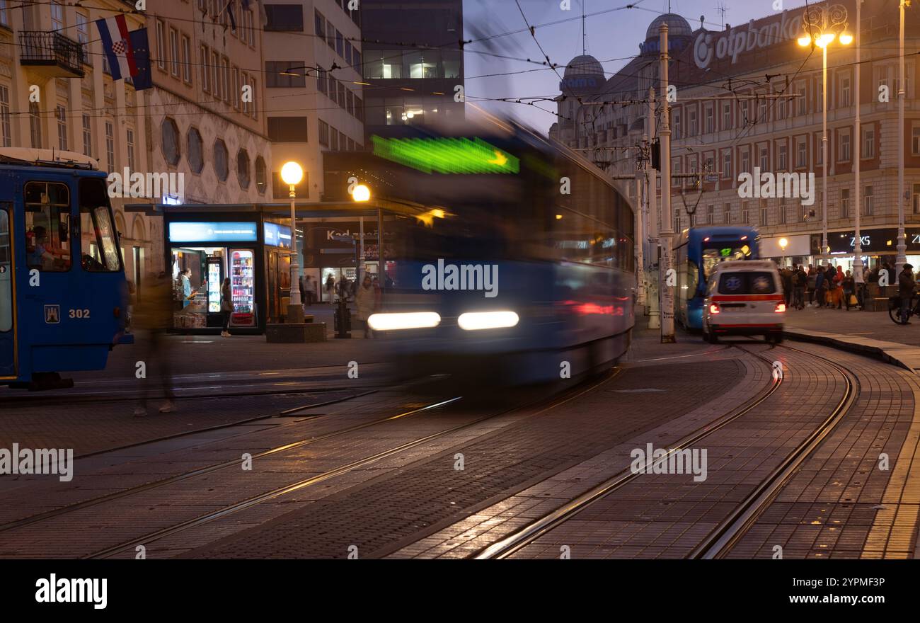 Fast electric tram passing on a city street iZagreb Croatia Stock Photo ...