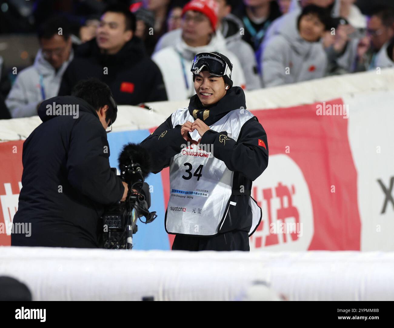 Beijing, China. 1st Dec, 2024. Yang Wenlong (R) of China reacts during the men's snowboard final ...