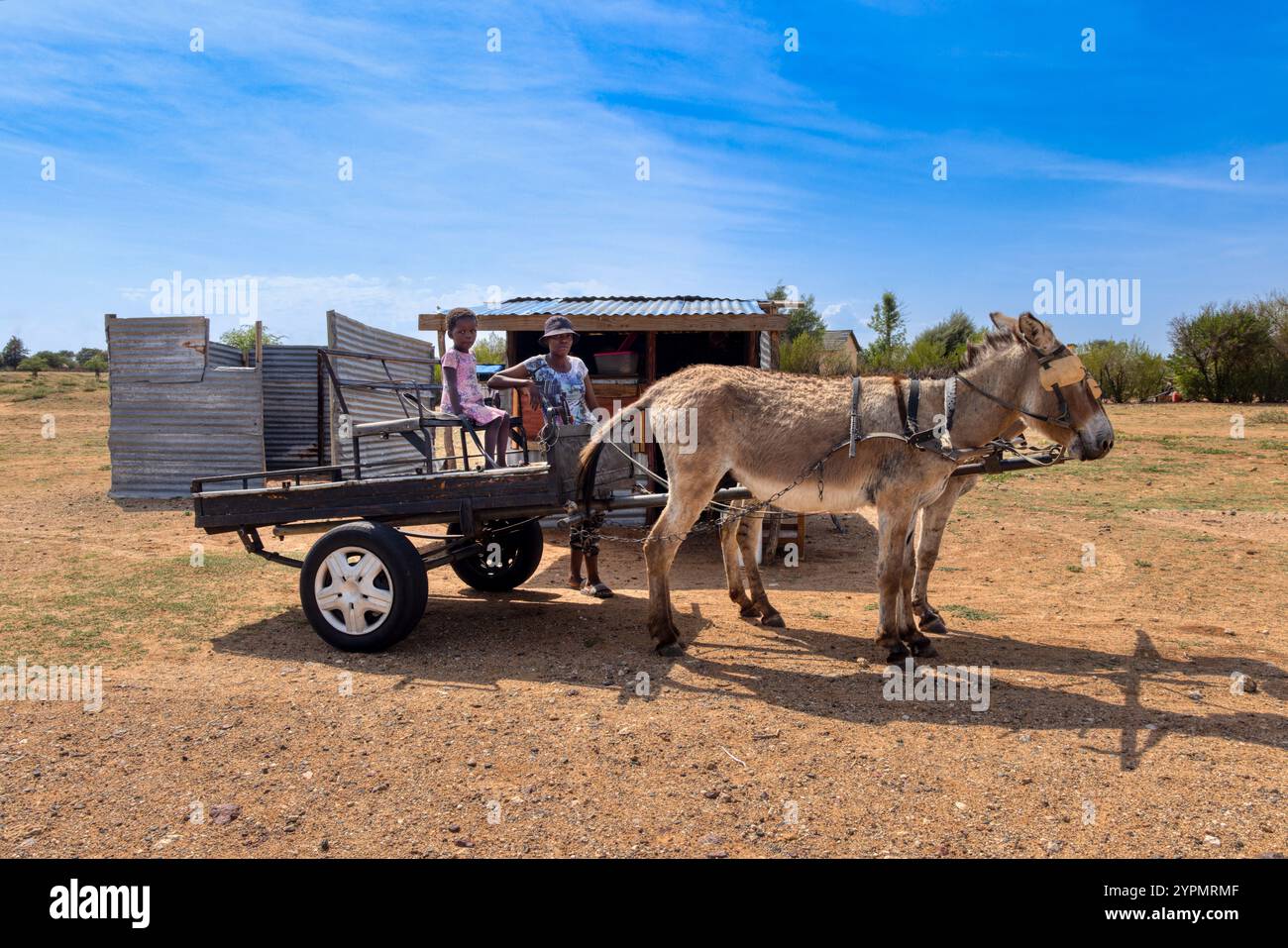 donkey cart, african mother and child next to tuck shop , in the ...