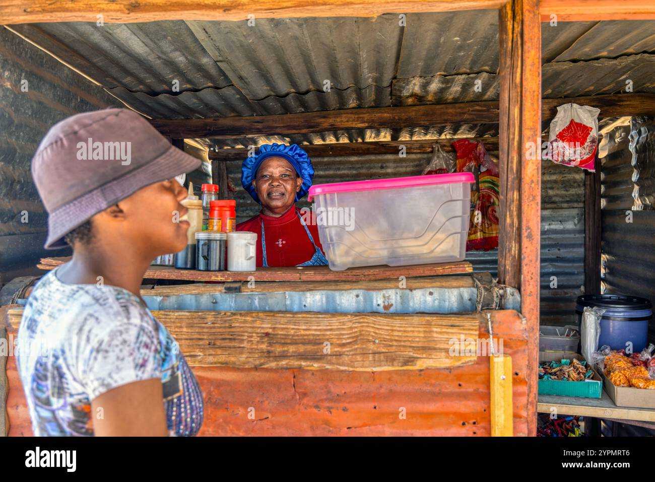 tuck shop , spaza shop, street vendor small retailer in a shack selling ...
