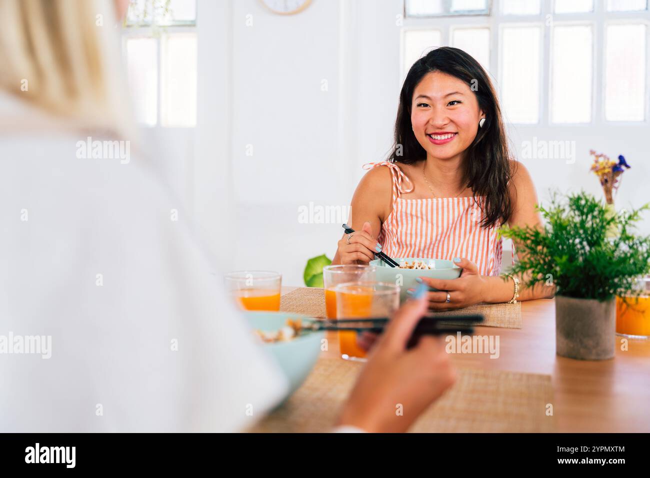 Multiethnic group of young friends meeting at home and eating poke ...