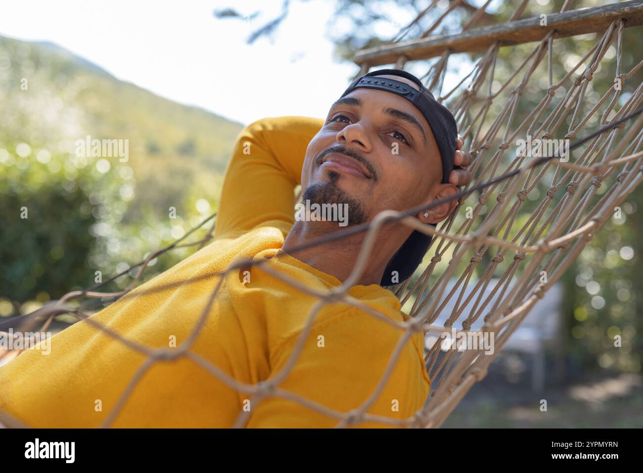 African American young man enjoying his stay at a glamping site in ...