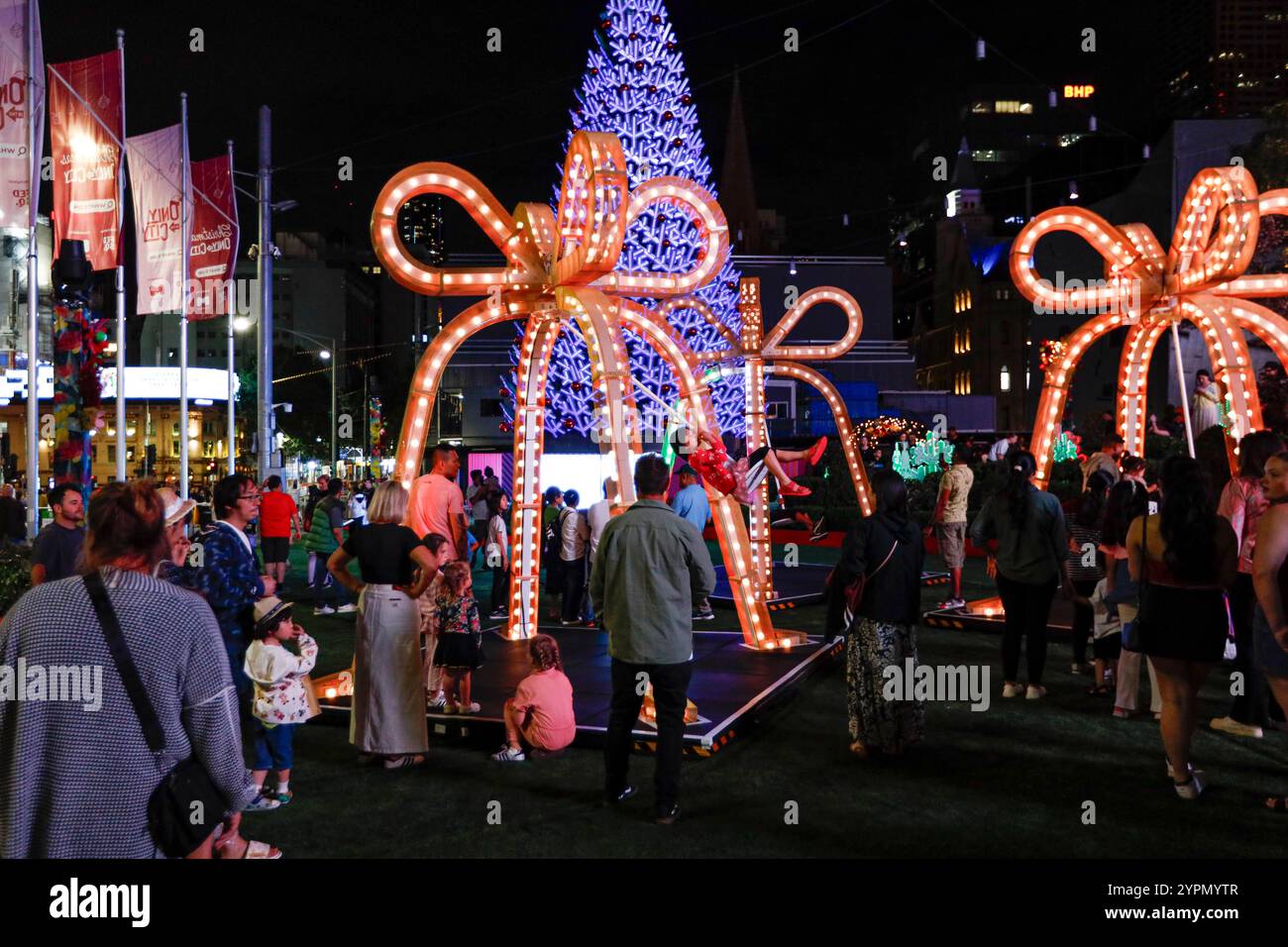 Visitors enjoy the festive Christmas lights at Federation Square ...