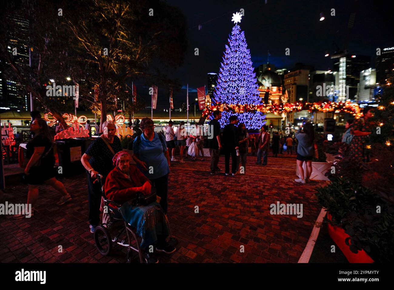 Visitors enjoy the festive Christmas lights at Federation Square ...