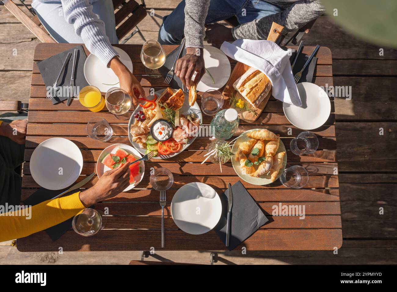Friends enjoying their vacation, eating lunch outdoor terrace of a ...