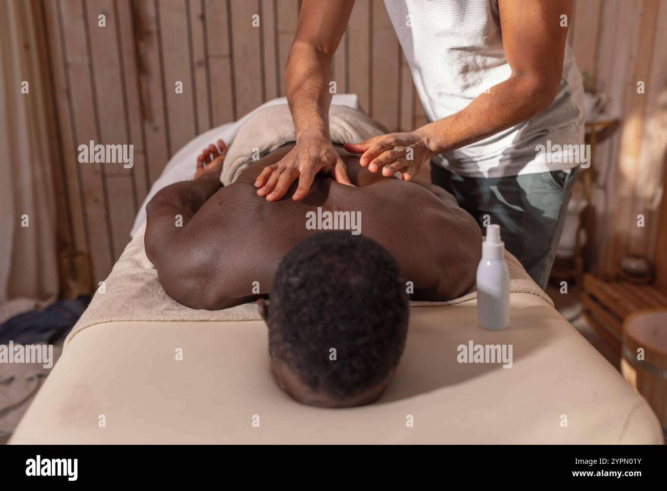 African American massage therapist providing relaxation treatment to ...