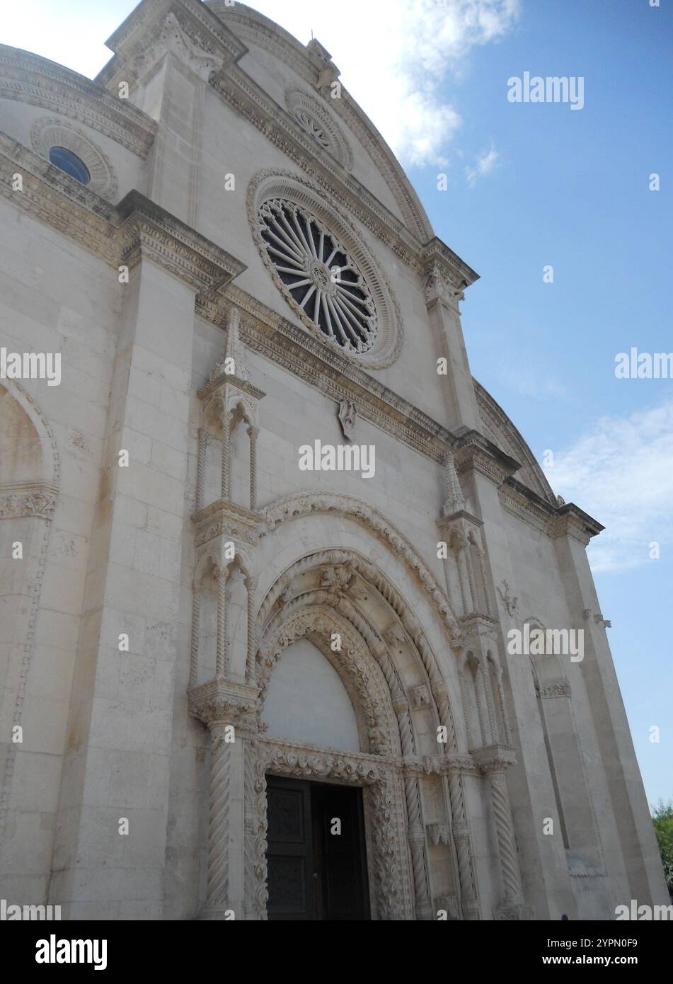An intricate church facade showcases detailed stonework under a clear ...