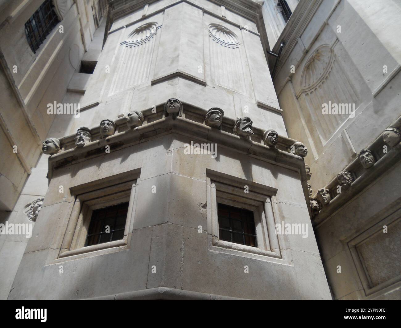 Intricate stone carvings adorn the corner of an historic building ...