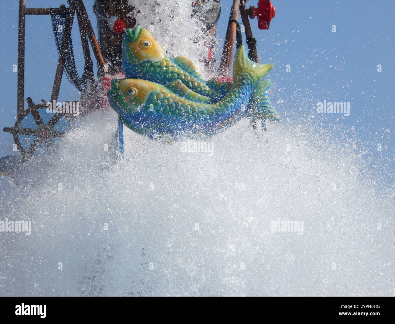 Two vibrant fish shaped inflatables are soaring through a splash of ...