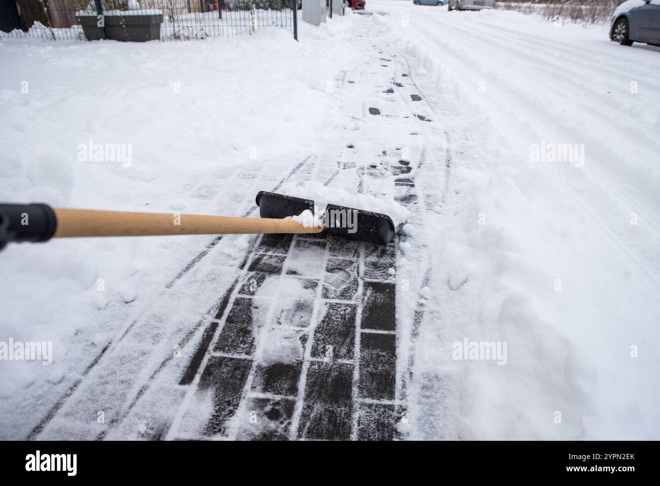 clearing snow from the sidewalk Stock Photo - Alamy