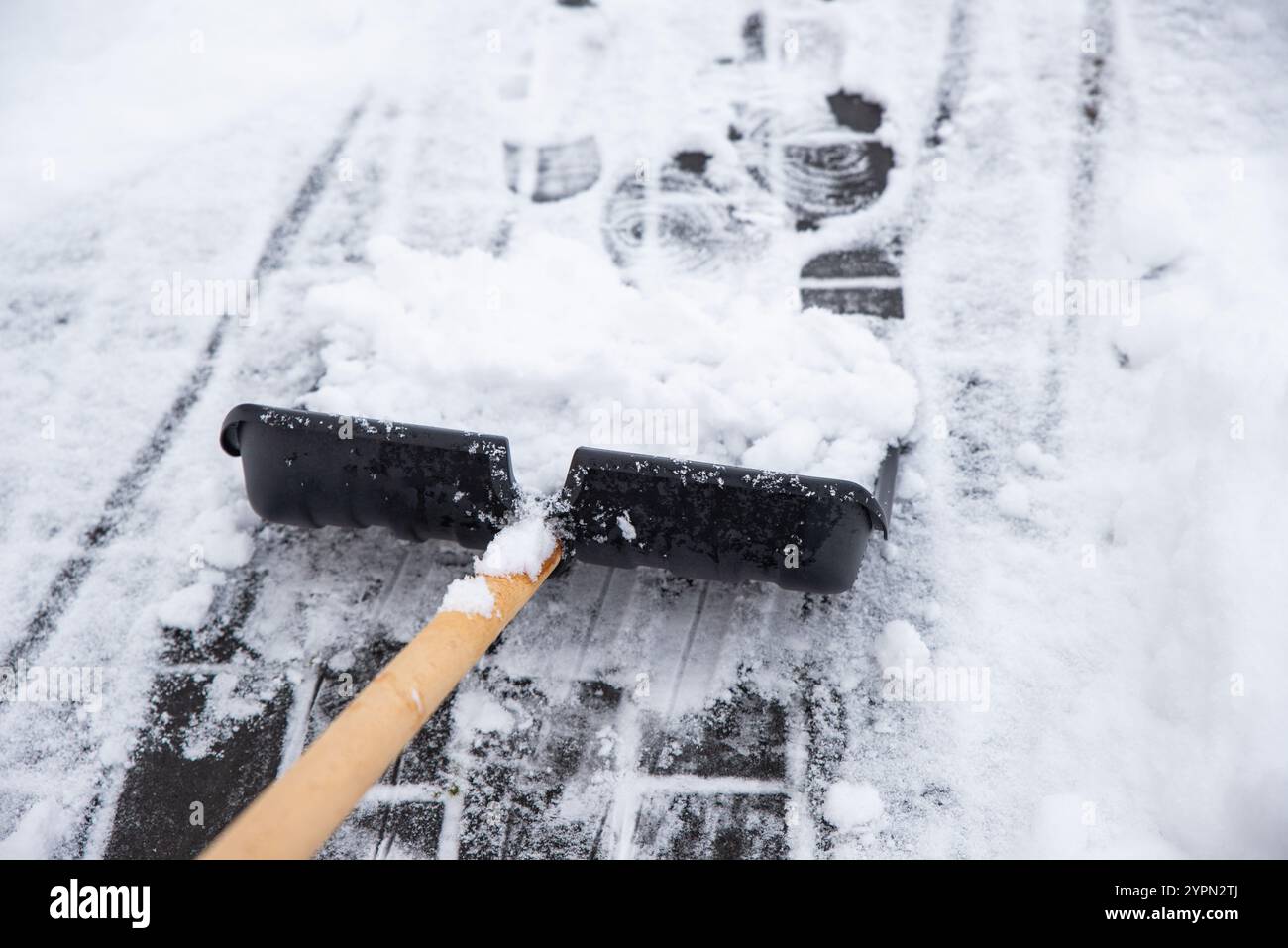 clearing snow from the sidewalk Stock Photo - Alamy