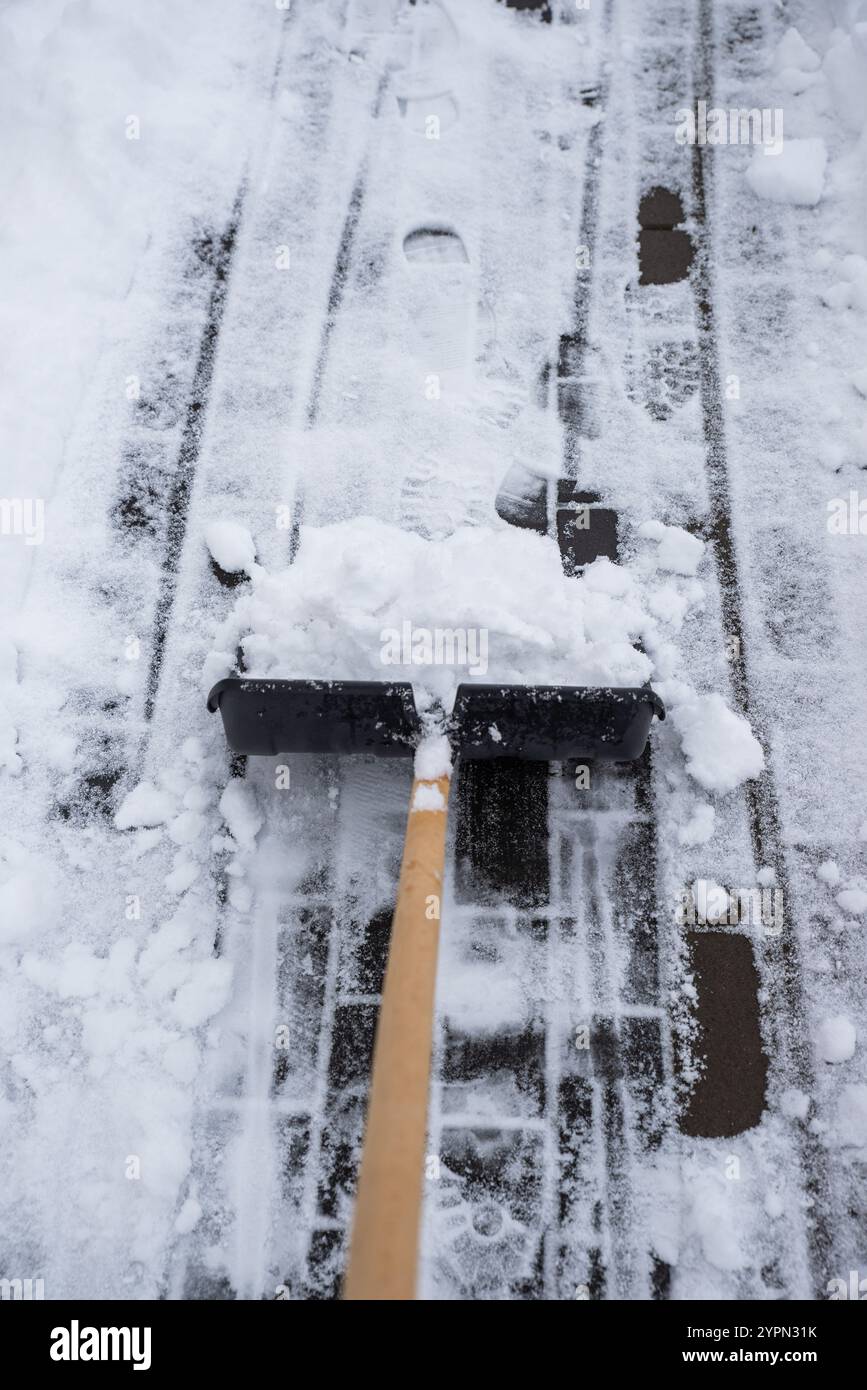 clearing snow from the sidewalk Stock Photo - Alamy