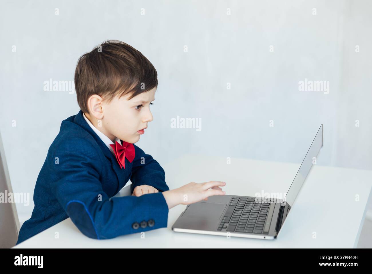 Boy In Business Suit Studying Playing On Laptop Stock Photo - Alamy