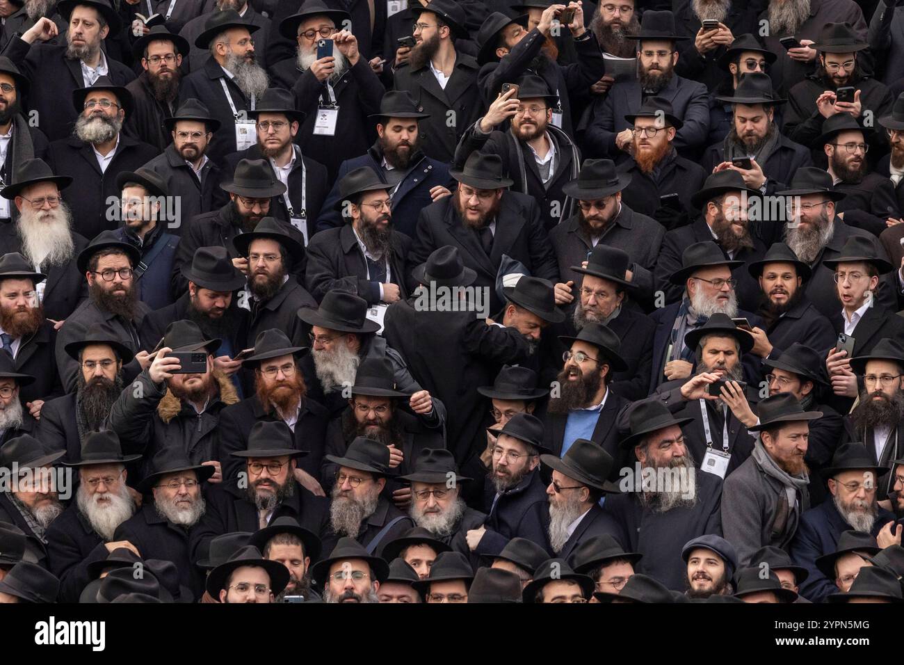 Hasidic Jewish rabbis climb up the scaffolding ahead of the annual ...