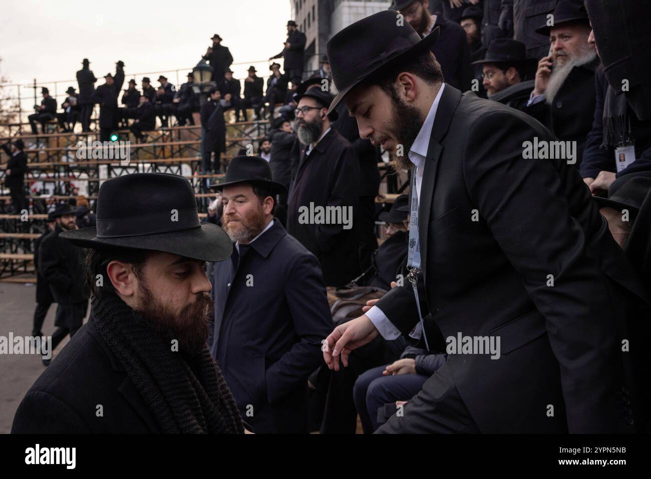Hasidic Jewish rabbis climb up the scaffolding ahead of the annual ...