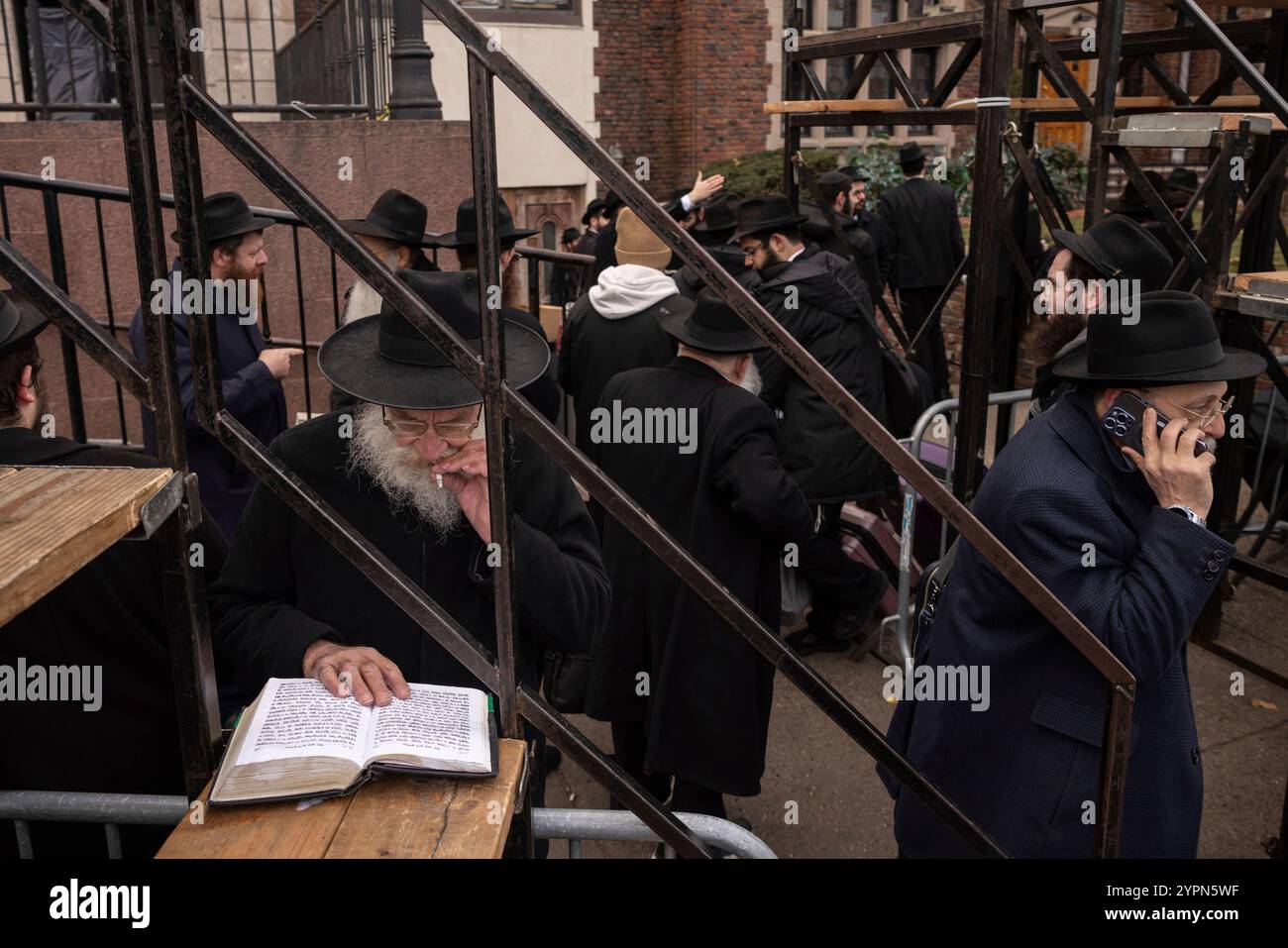 A Hasidic Jewish rabbi reads the torah after the annual group portrait ...