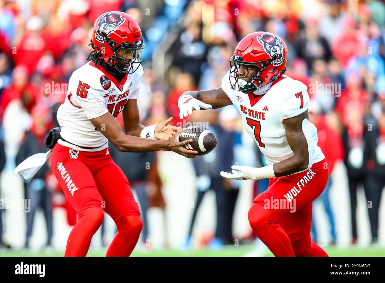 November 30, 2024: NC State freshman CJ Bailey (16) hands off ball to ...
