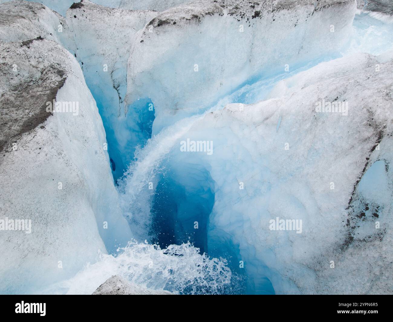 A deep ice crevasse within Mendenhall Glacier, Alaska, showcasing clear ...