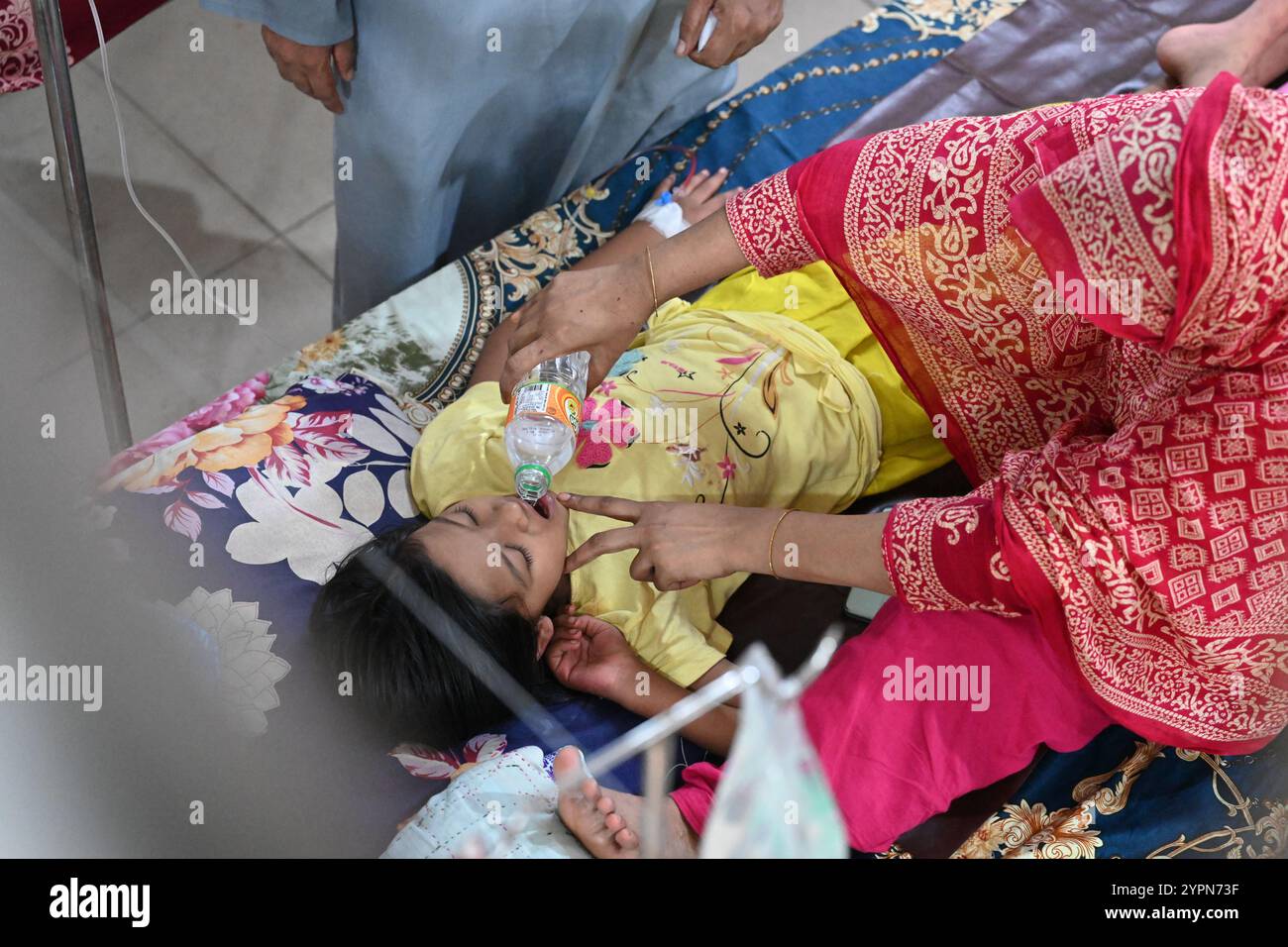 Patients suffering from dengue fever receive treatment inside the ...