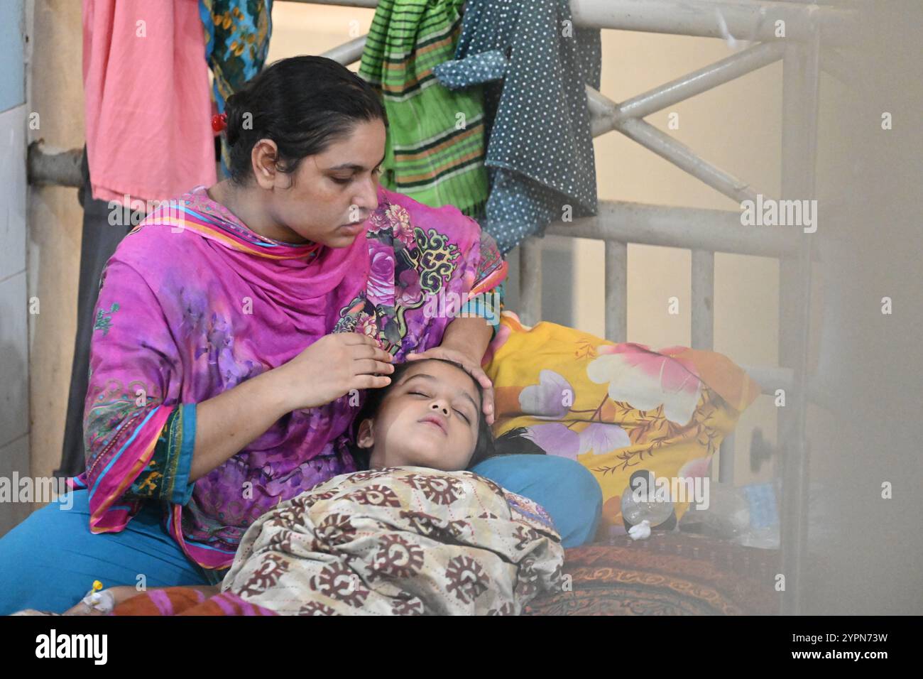 Patients suffering from dengue fever receive treatment inside the ...