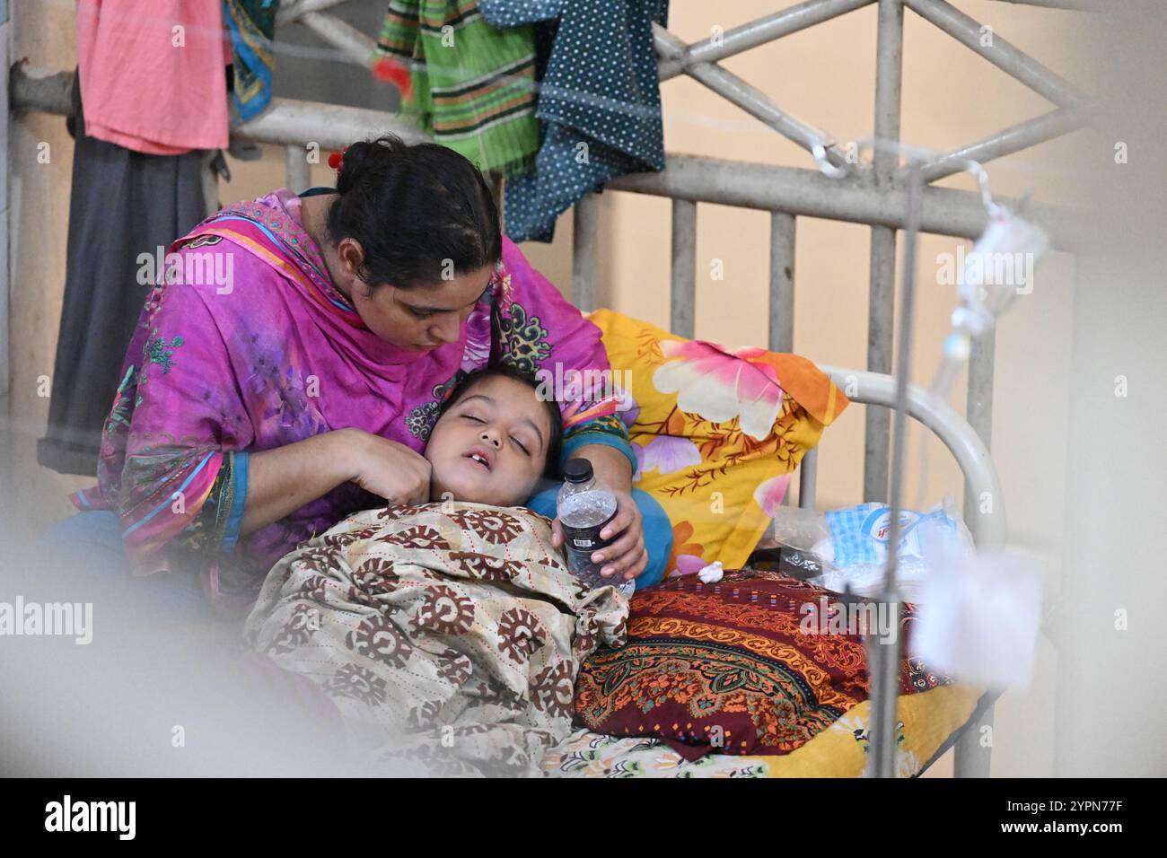 Patients suffering from dengue fever receive treatment inside the ...