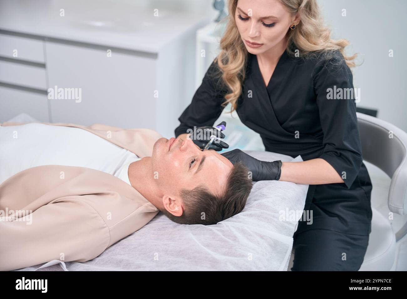 Man visiting cosmetologist office for botulinum toxin injections to get ...