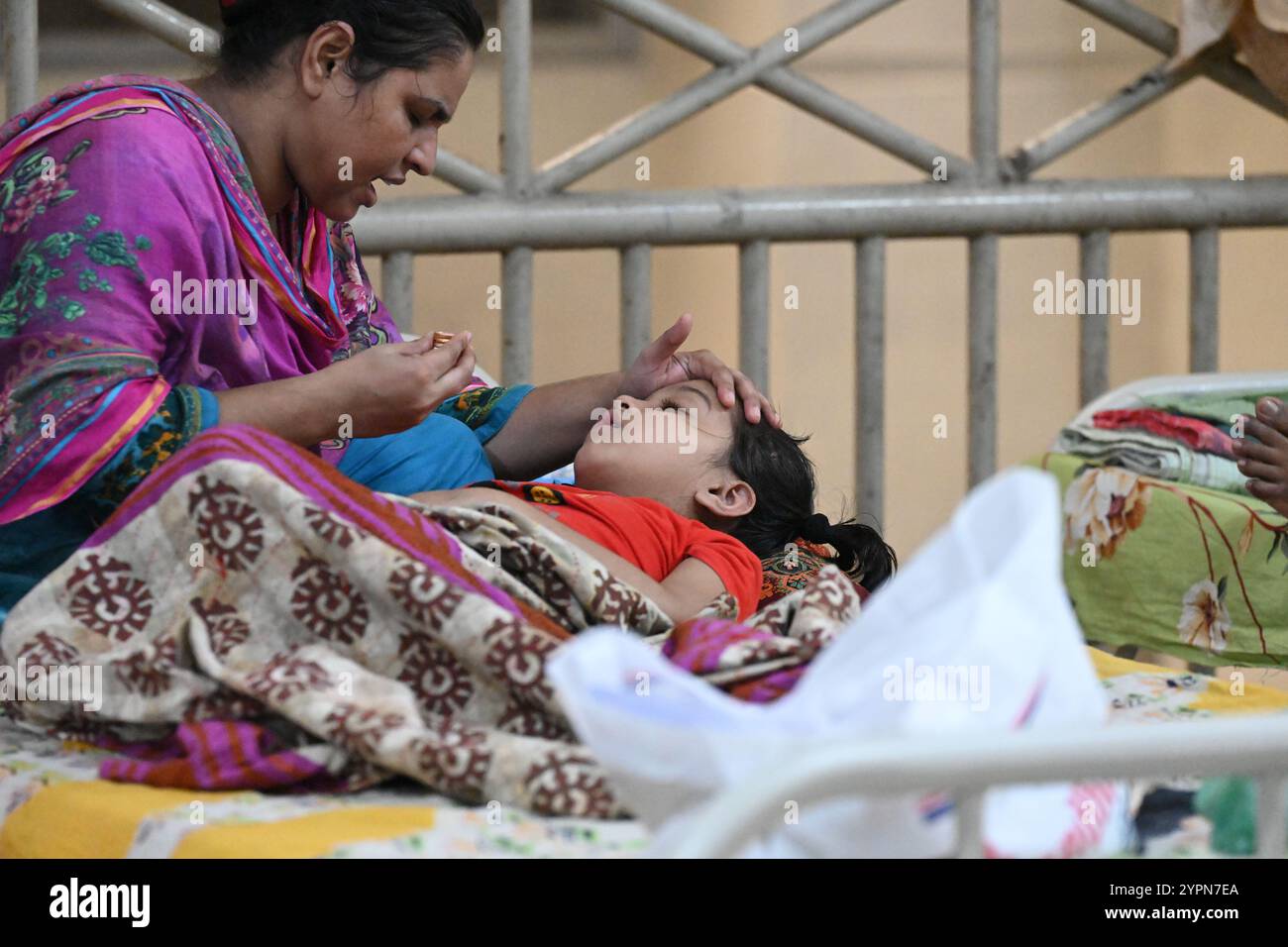 Patients suffering from dengue fever receive treatment inside the ...
